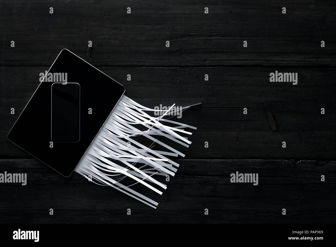 Paperless office, mobile devices on black background Stock Photo - Alamy