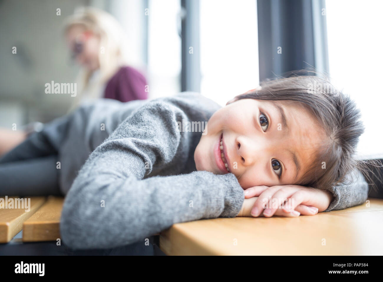 Portrait smiling schoolgirl lying bench school hi-res stock photography ...