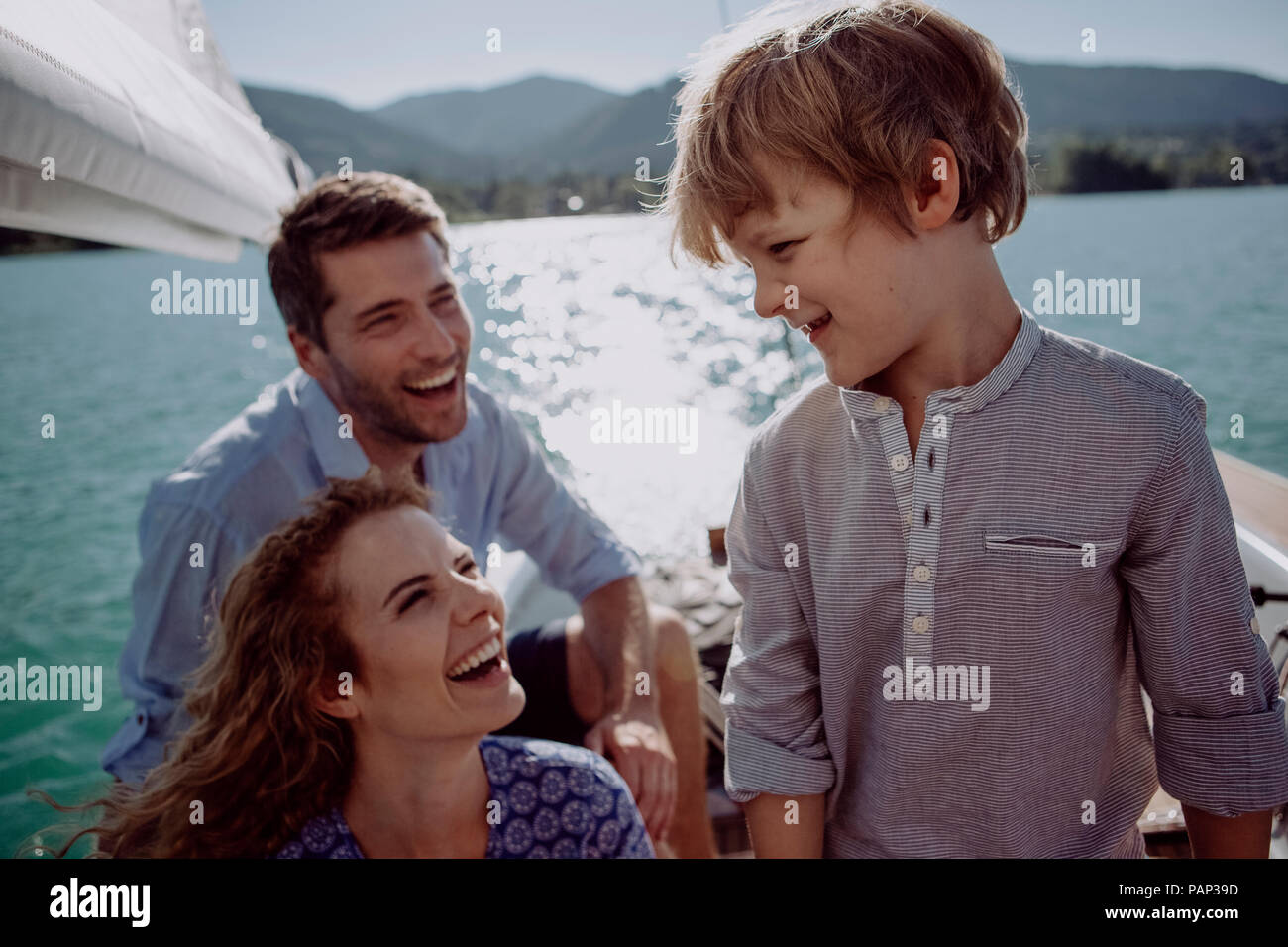 Happy family on a sailing boat Stock Photo - Alamy