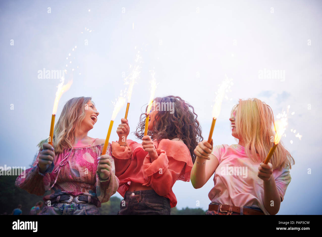Friends with sparklers dancing at music festival Stock Photo - Alamy
