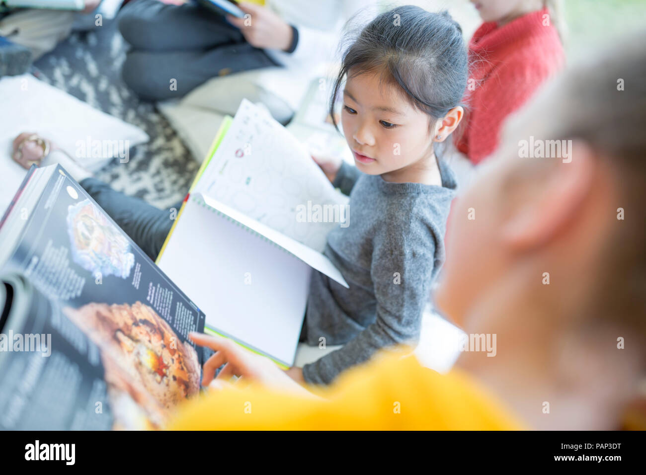 Pupils reading together in school Stock Photo - Alamy