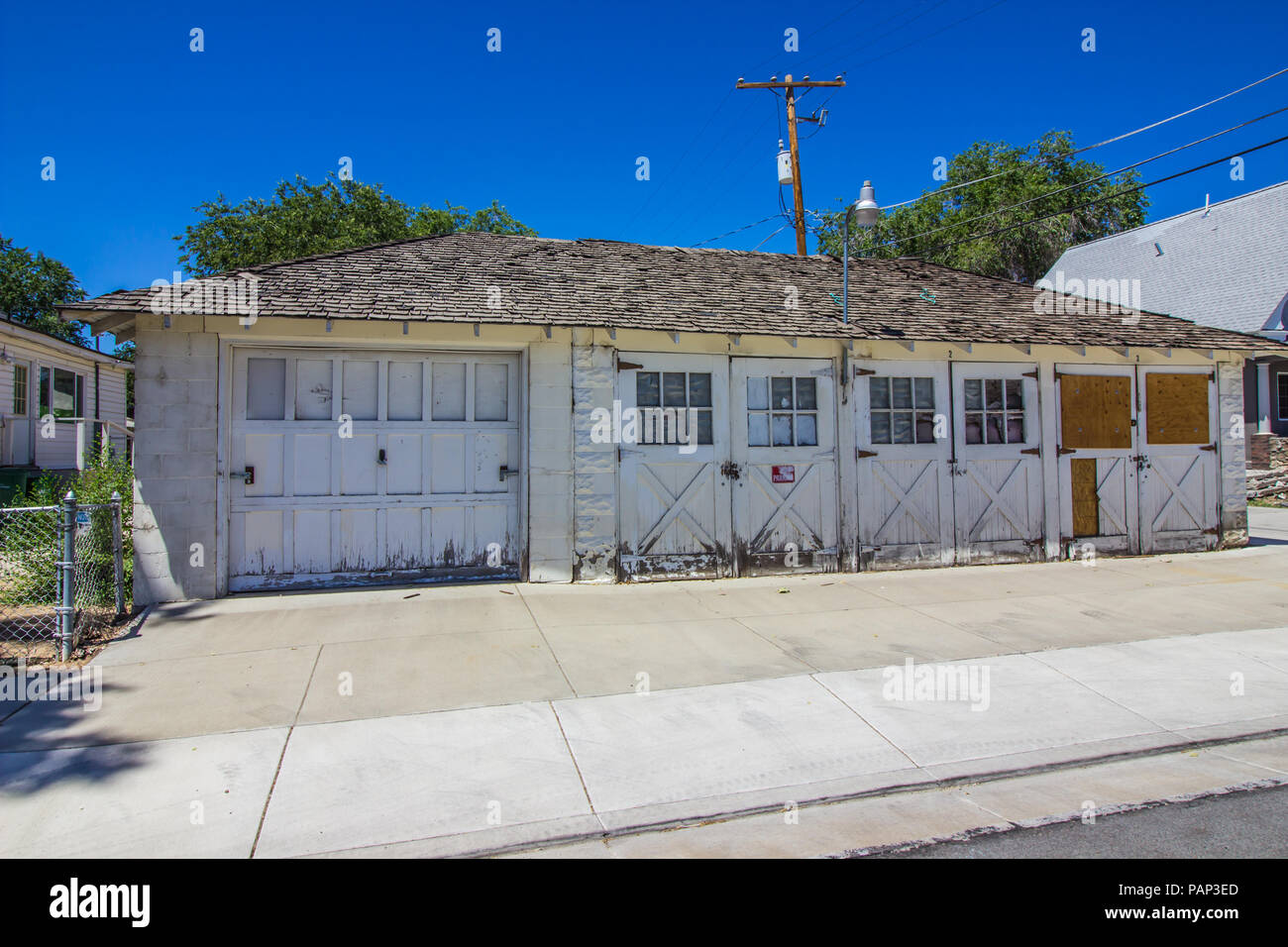 Multi Door Weathered Garage With Boarded Up Windows Stock Photo - Alamy