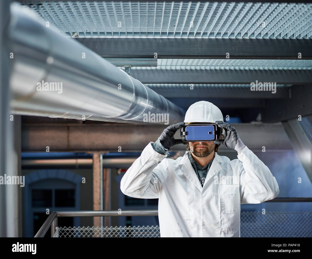 Technician hard hat looking through vr glasses hi-res stock photography ...