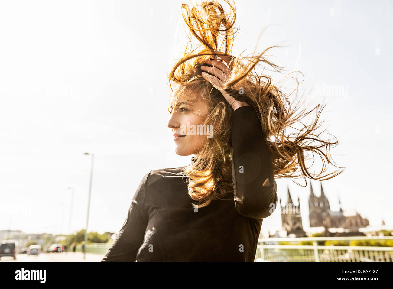 Germany, Cologne, portrait of smiling woman with blowing hair Stock ...