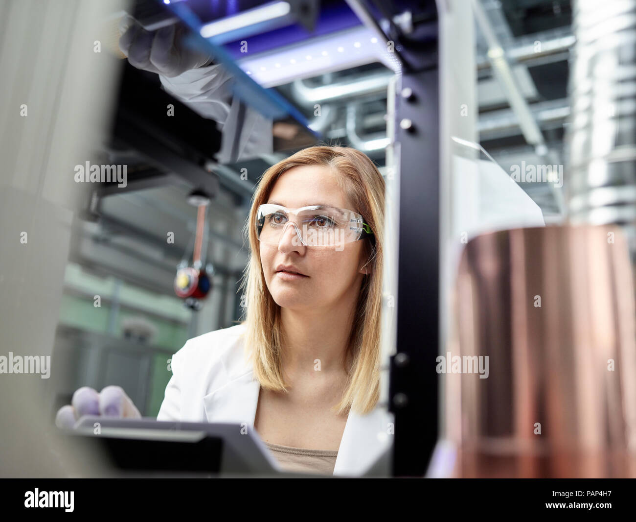 Female technician checking 3D printer Stock Photo - Alamy
