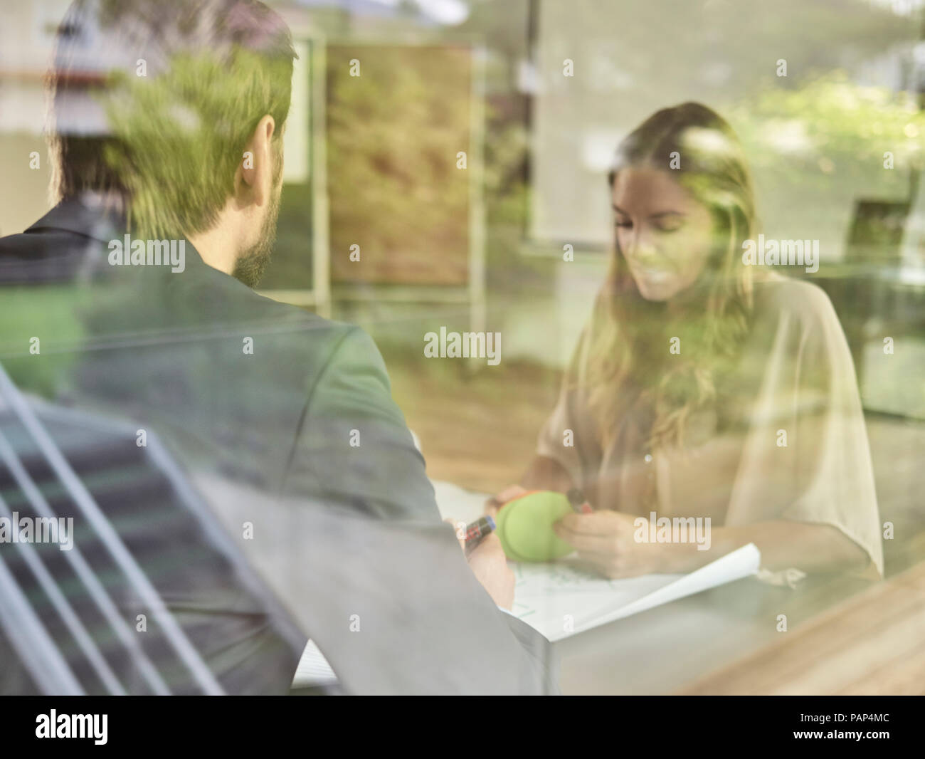 Colleagues collaborating on planning hi-res stock photography and ...