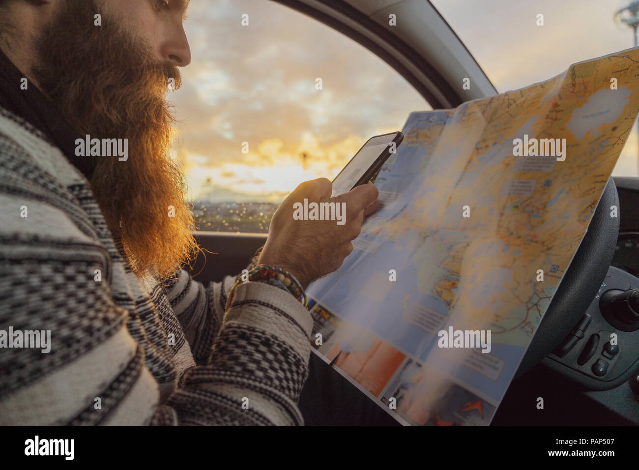 Man using smartphone in car, looking at map for directions Stock Photo ...