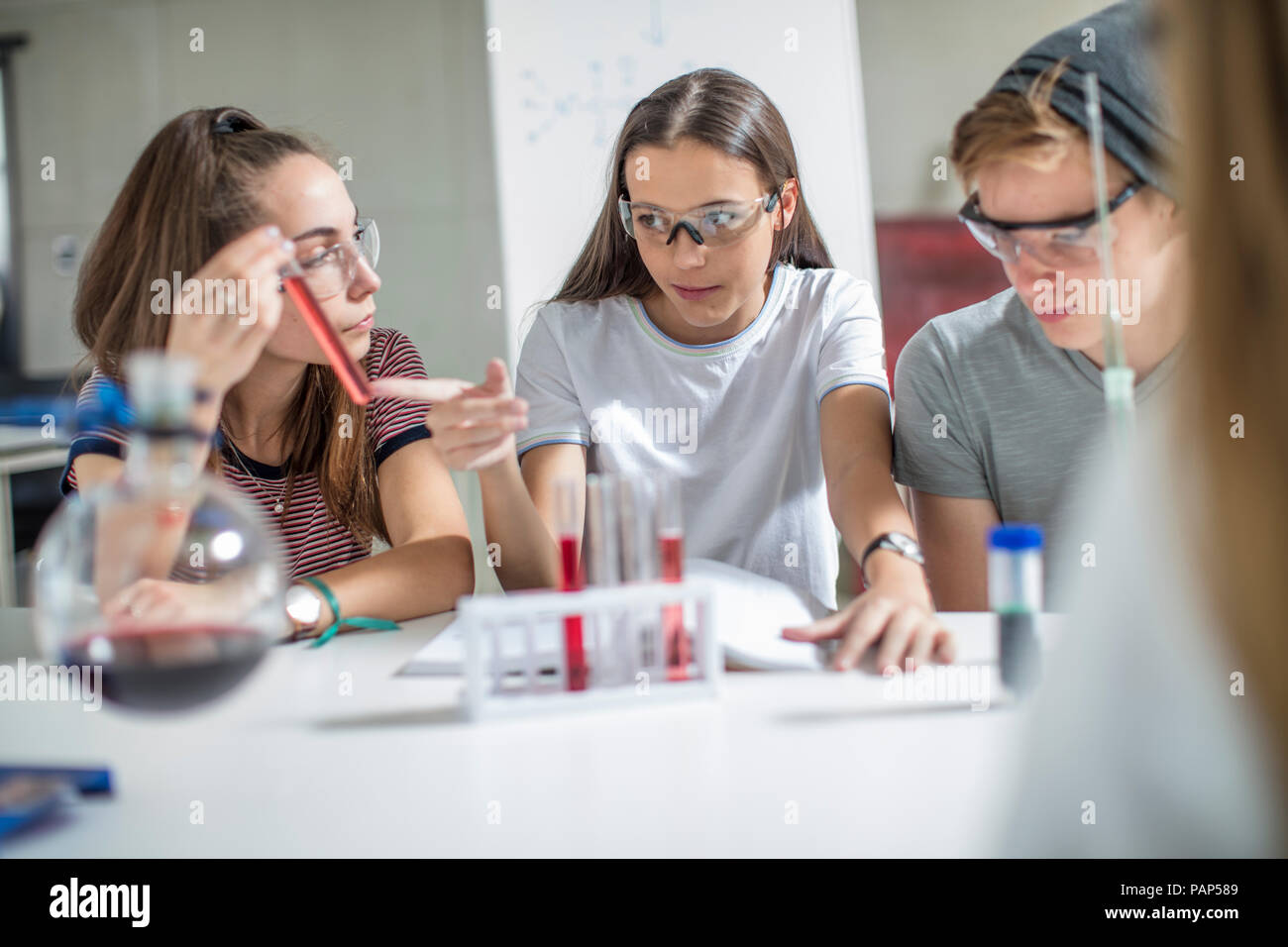Students in science class experimenting with test tubes Stock Photo - Alamy