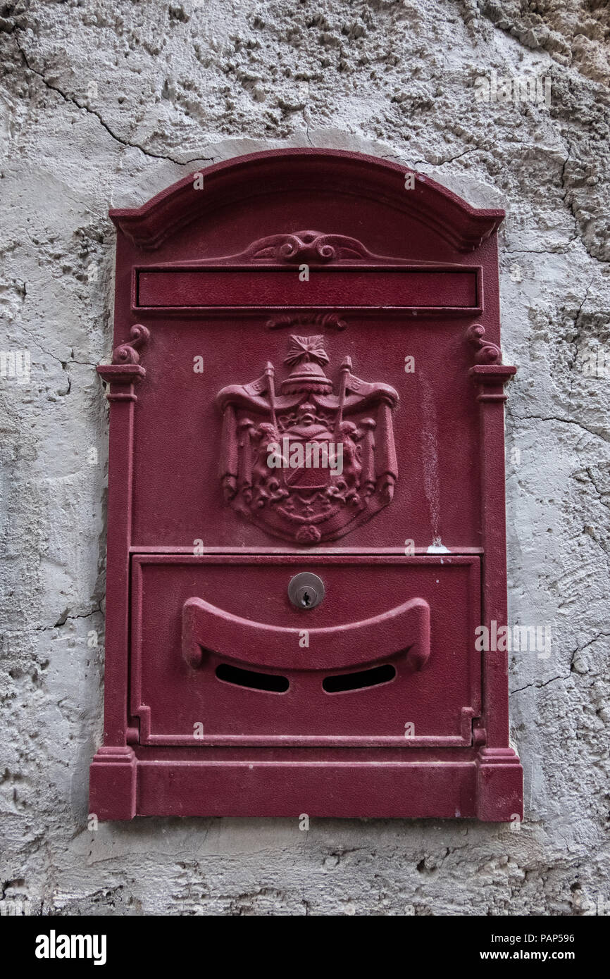 Red mailbox with rough concrete wall in the background Stock Photo - Alamy