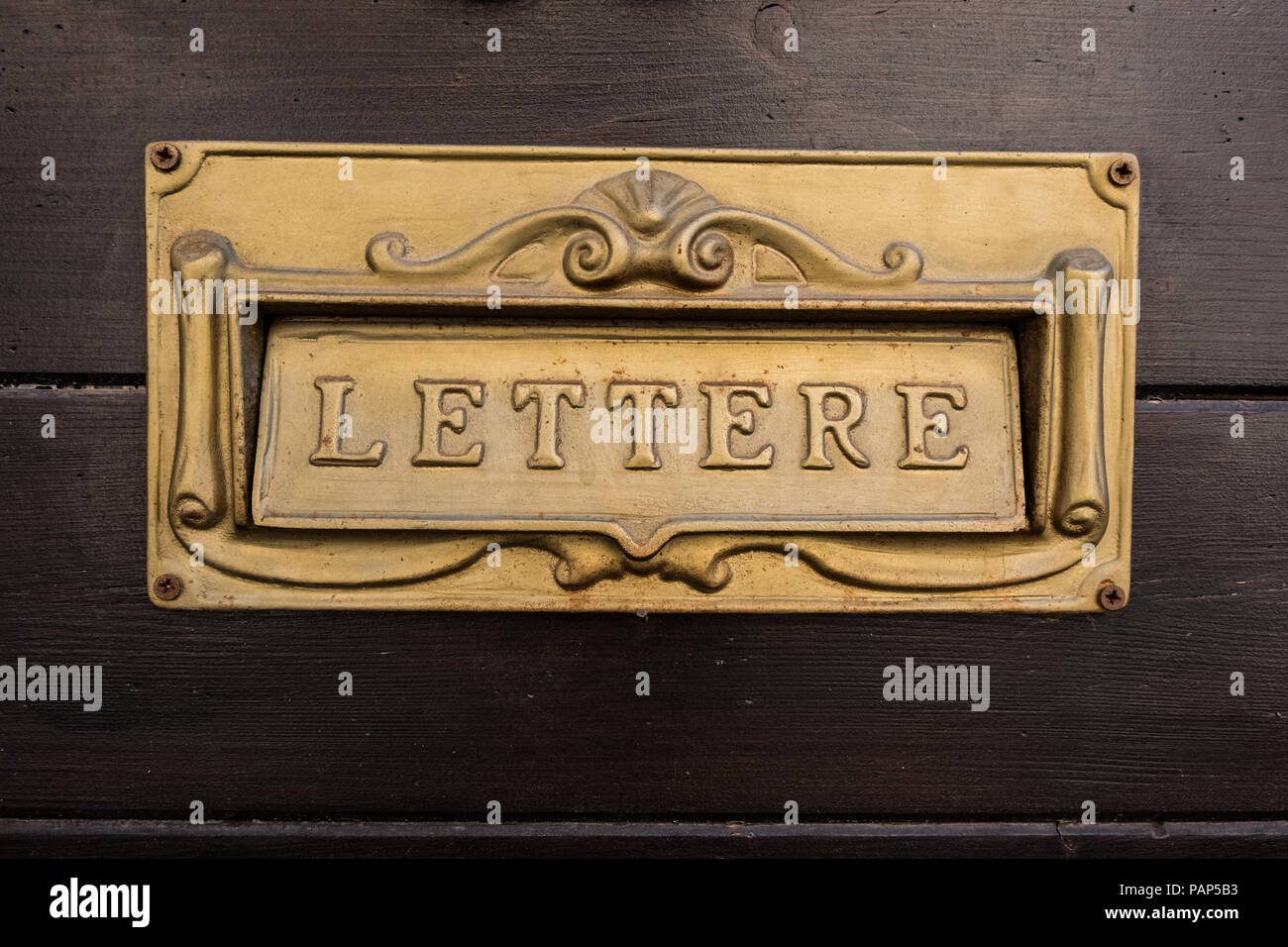 Golden mailbox with wood wall background Stock Photo - Alamy
