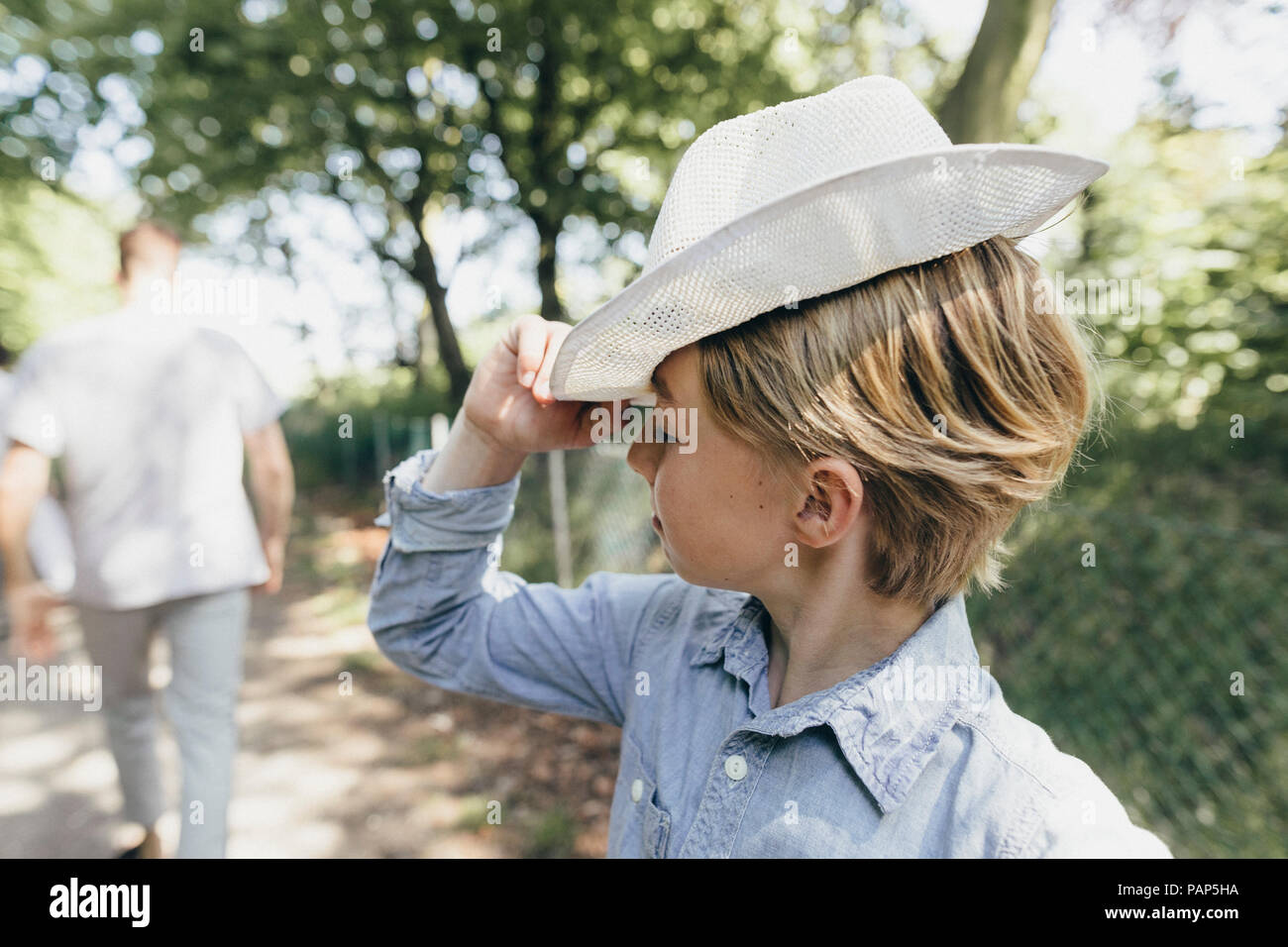 Boy wearing a hat on forest path Stock Photo - Alamy