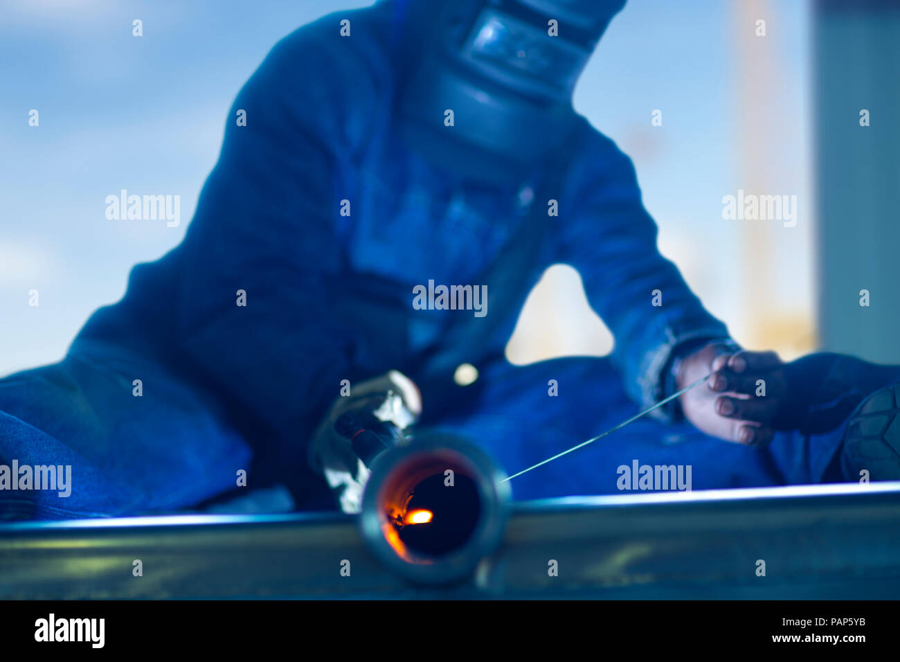 Welder in industrial plant welding tanks Stock Photo - Alamy