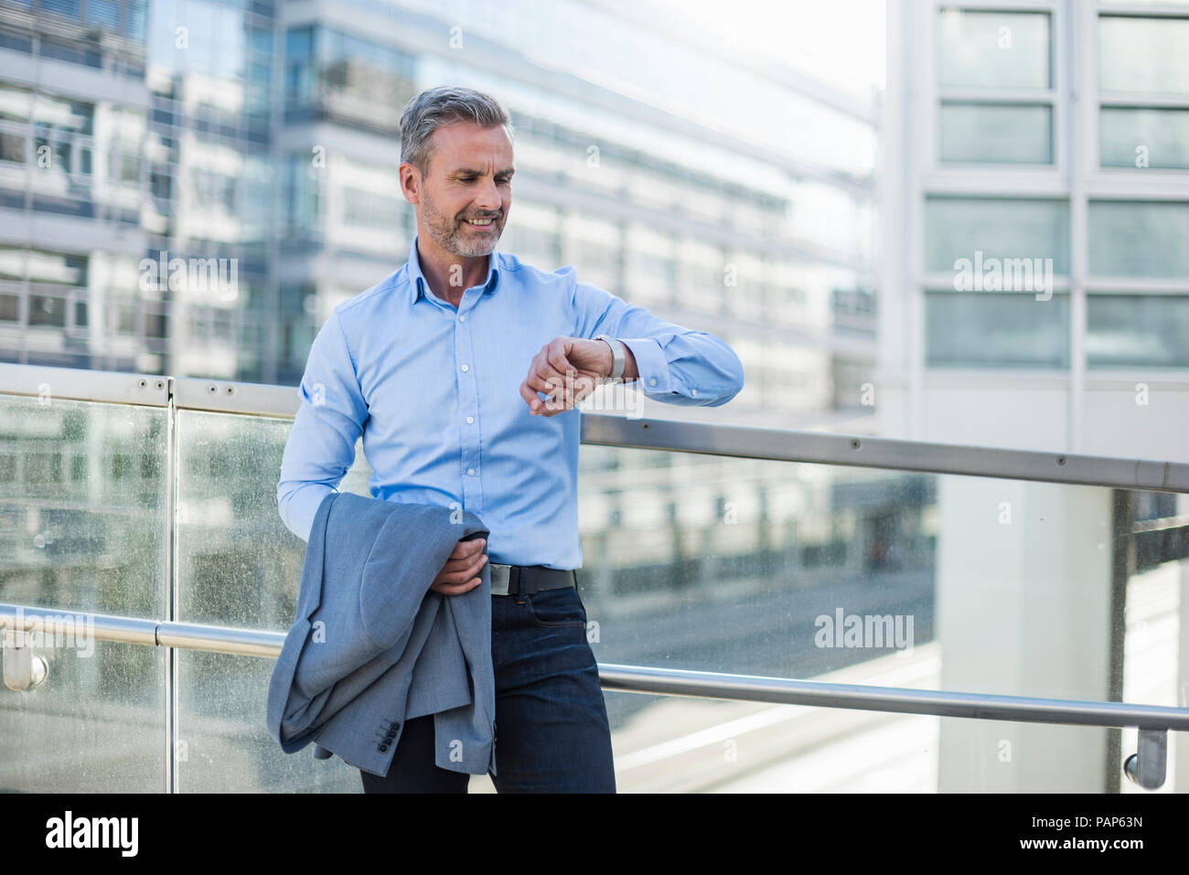 Waiting businessman checking the time Stock Photo - Alamy