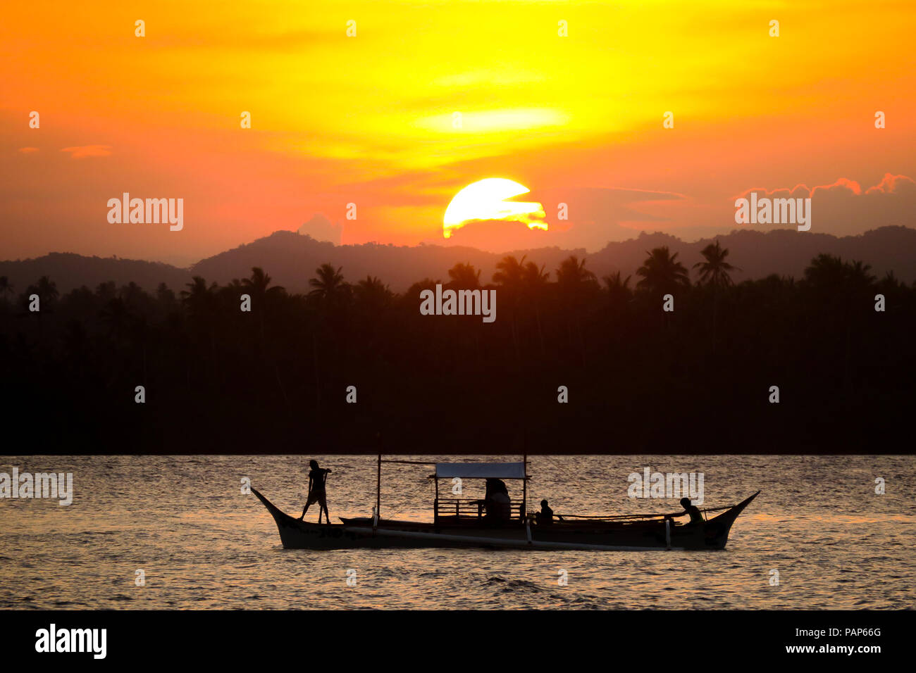 Tour Boat and Guides silhouette With Incredible large Orange setting ...
