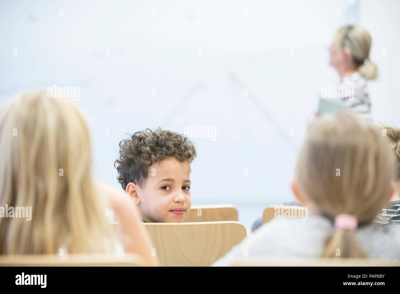 Portrait of schoolboy with classmates and teacher in class Stock Photo ...
