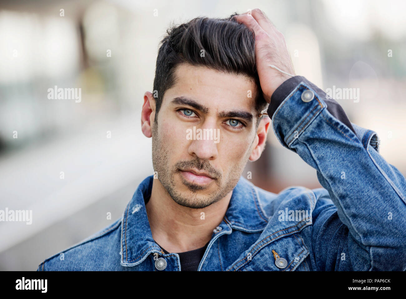 Portrait of young man wearing jeans jacket Stock Photo - Alamy