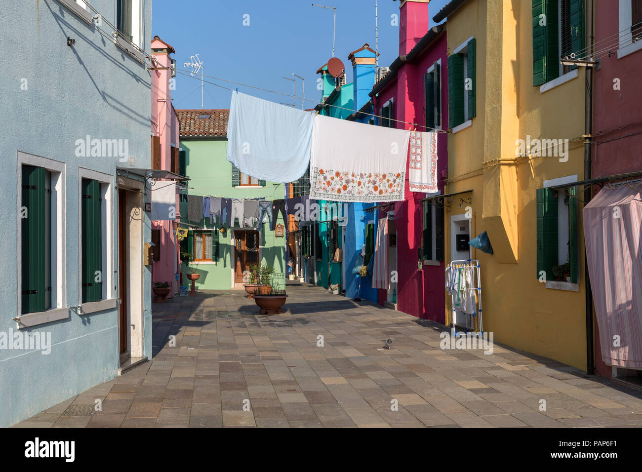Italy, lagoon of Venice, Burano, colorful houses and laundry hanging ...