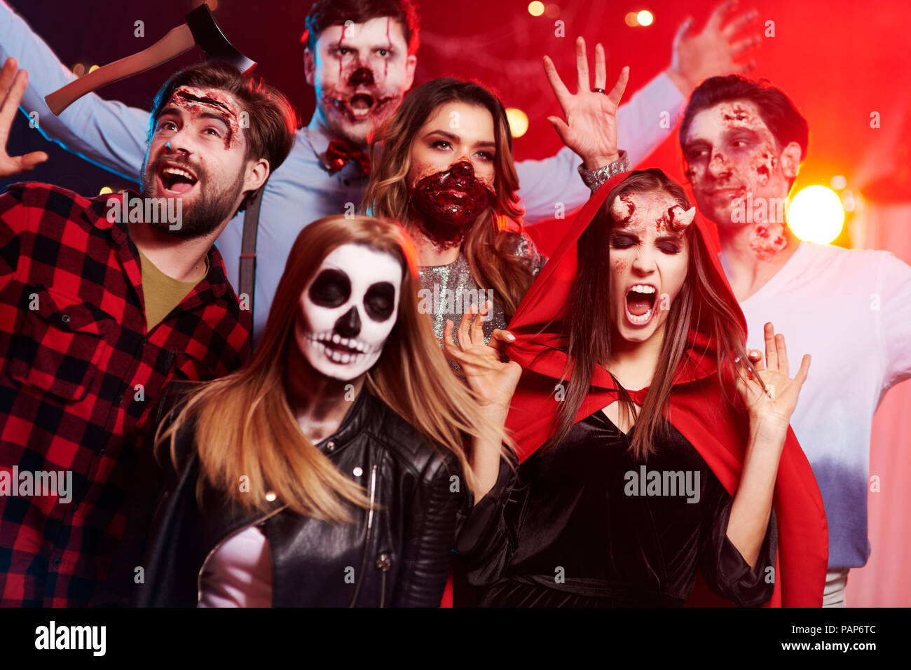 Friends in creepy costumes having fun at Halloween party Stock Photo ...