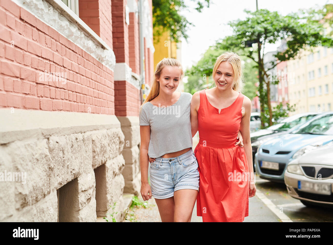 Two friends walk arms around hi-res stock photography and images - Alamy
