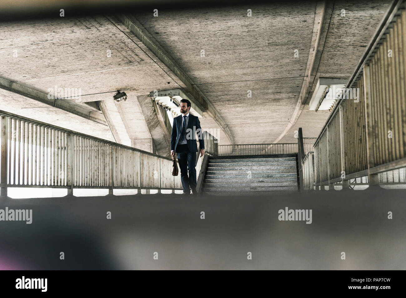 Businessman walking at underpass Stock Photo - Alamy