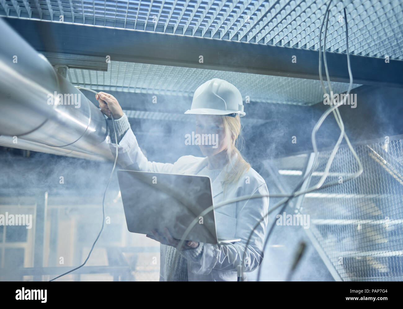 Female technician working pipeworks hi-res stock photography and images ...
