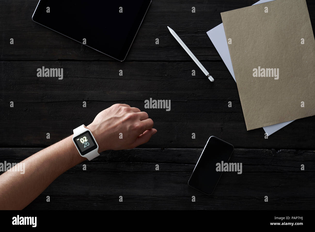 Man wearing smartwatch in office Stock Photo - Alamy