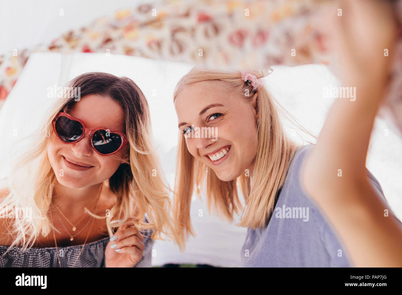 Portrait of two happy young women in a teepee Stock Photo - Alamy