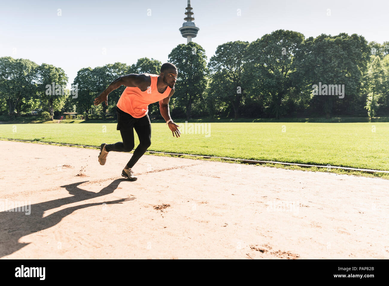 Young athlete on sports field training running Stock Photo - Alamy