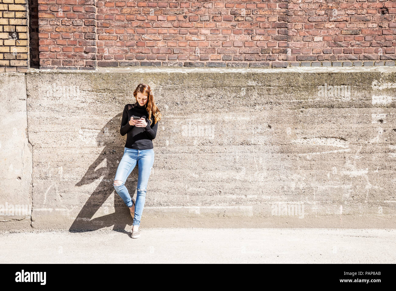 Woman Leaning Against Wall