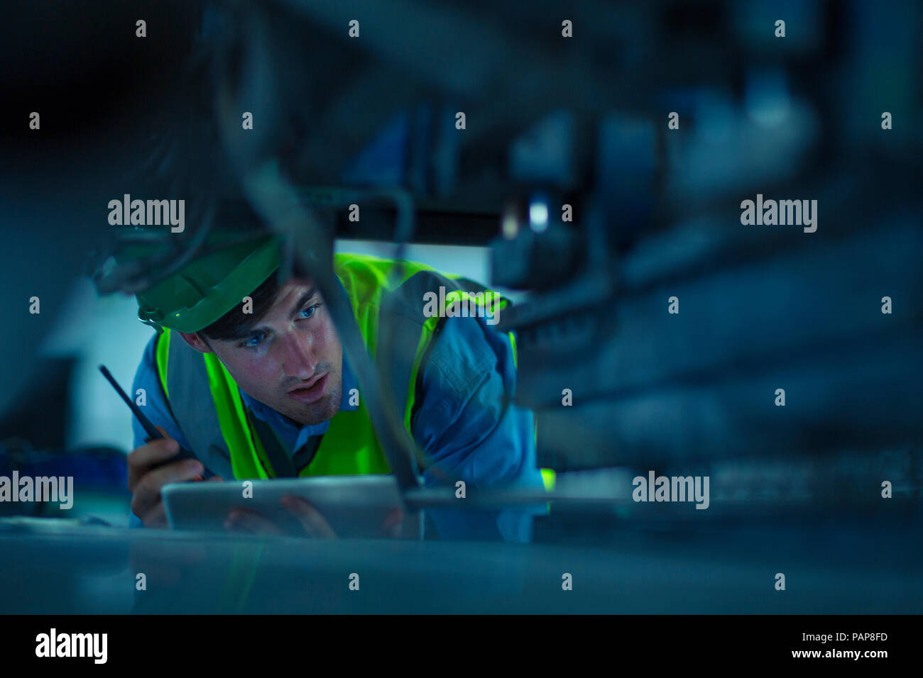 Engineer in industrial plant inspecting machines Stock Photo - Alamy