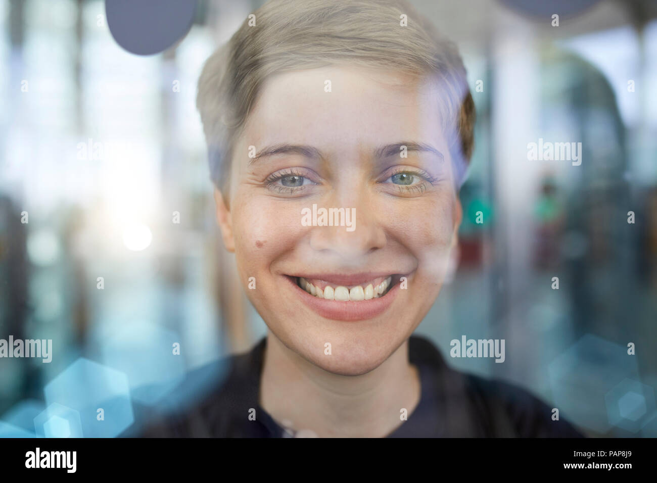 Portrait of blond businesswoman behind glass pane Stock Photo - Alamy