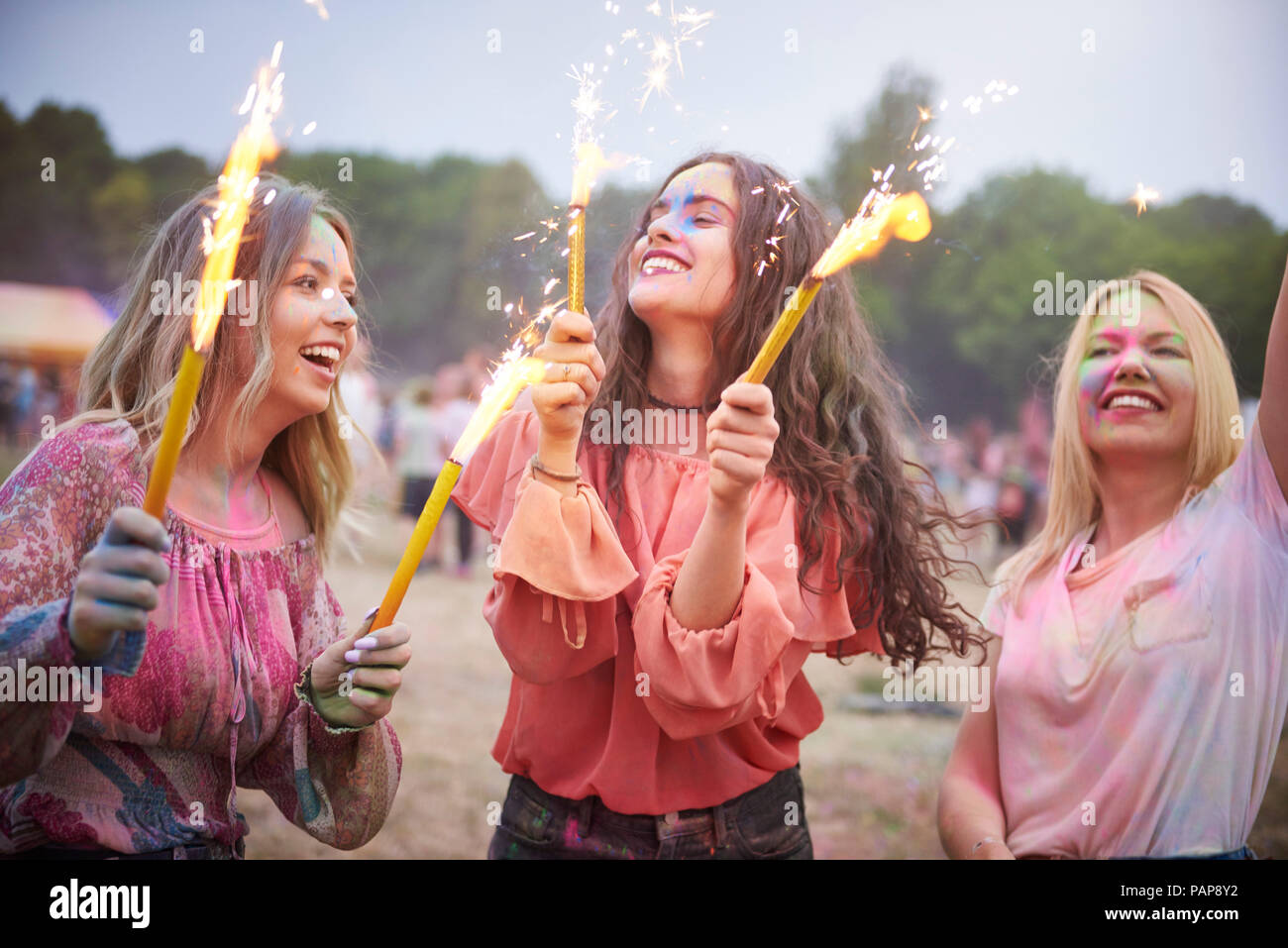 Friends with sparklers dancing at music festival Stock Photo - Alamy