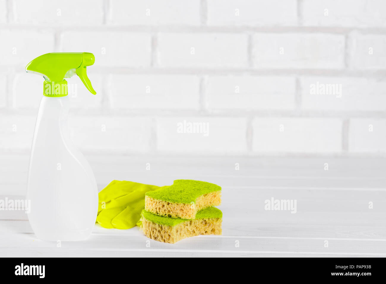 Close up picture of a house-cleaning spray, hand holding sponge, on an ...