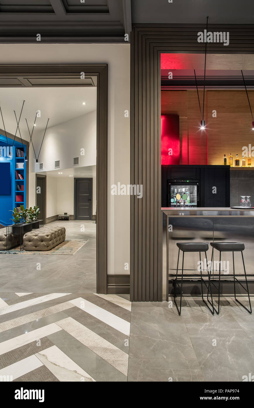 Modern hallway and a bar in a hotel with light walls and a tiled floor ...