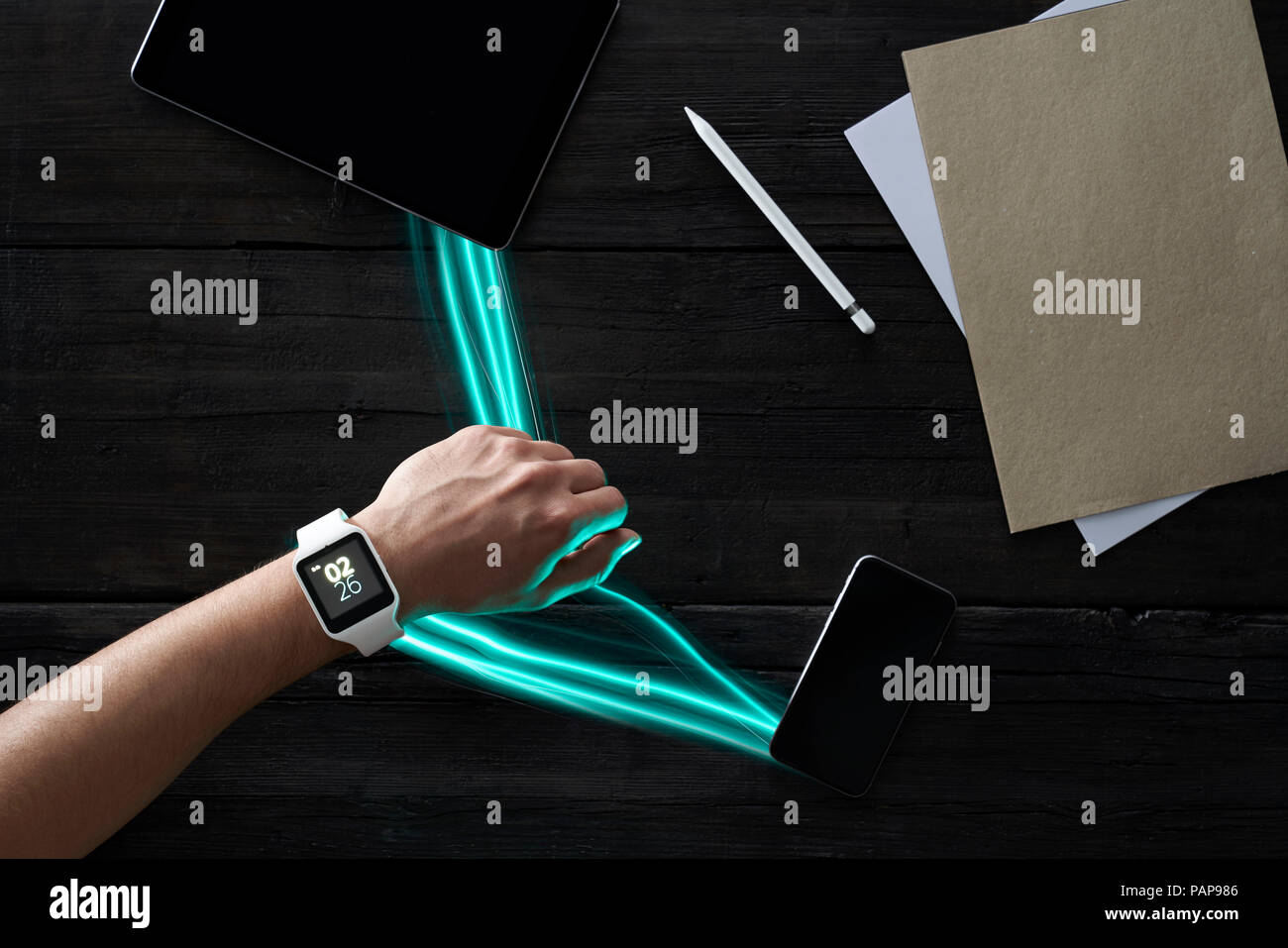 Man wearing smartwatch in office, connecting to portable devices Stock ...