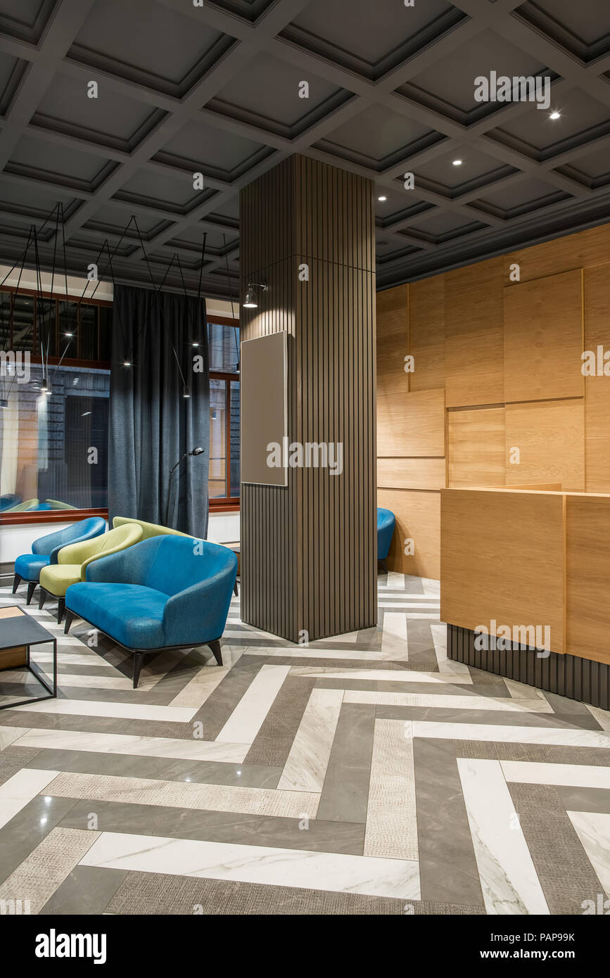 Fine interior with luminous lamps in the hotel with dark ceiling and ...