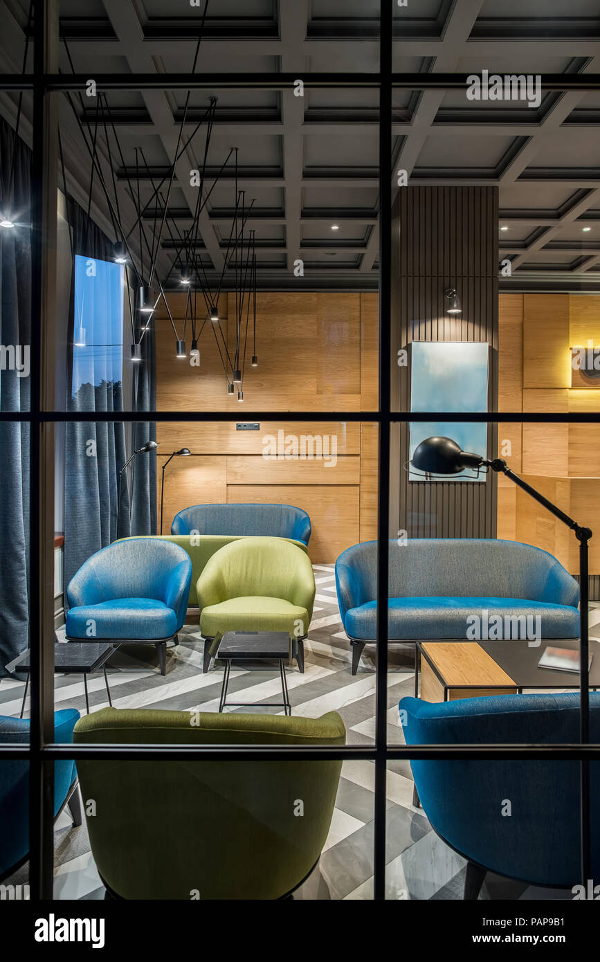 Illuminated interior in the hotel with dark ceiling and patterned tiled ...