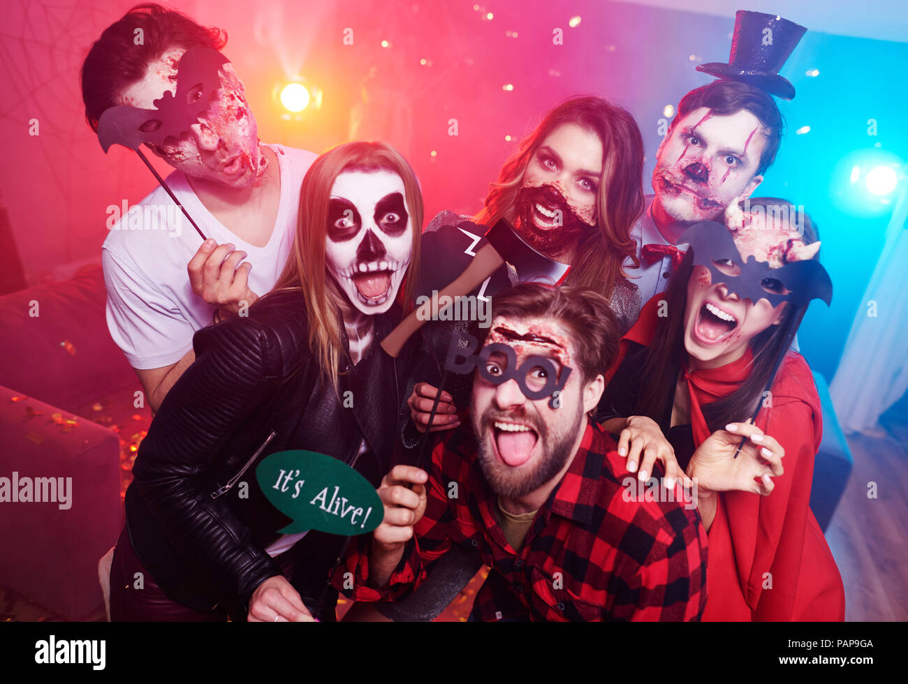 Friends in creepy costumes having fun at Halloween party Stock Photo ...