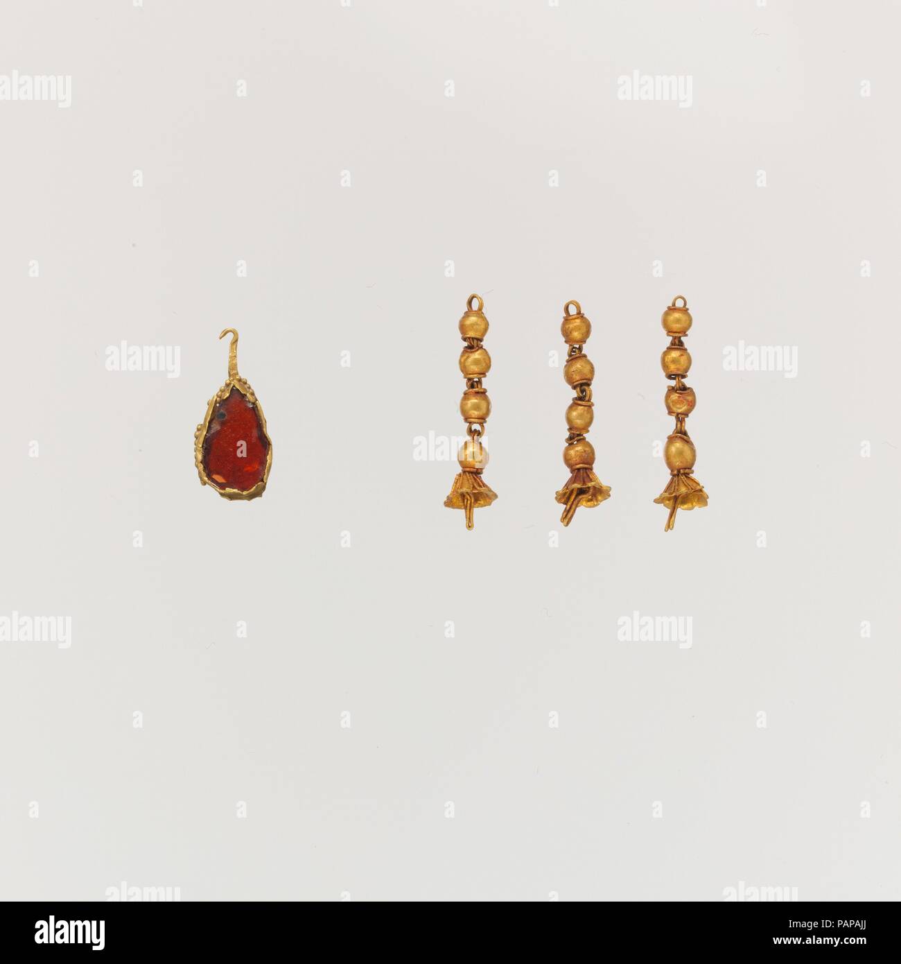 Gold pendant with garnet and three gold tassels. Culture: Greek, South ...