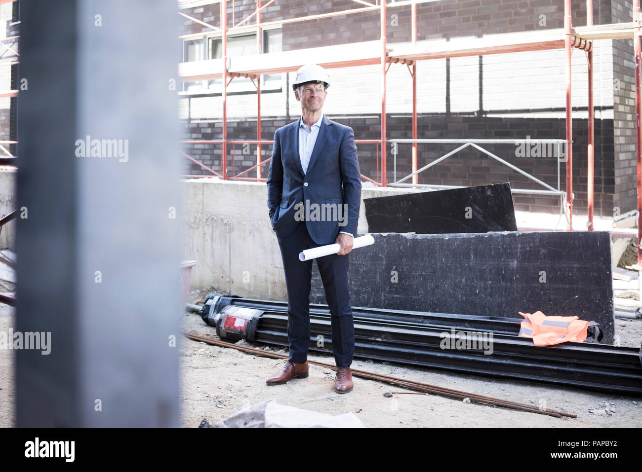 Confident architect wearing hard hat standing on construction site ... Confident architect wearing hard hat standing on construction site ...