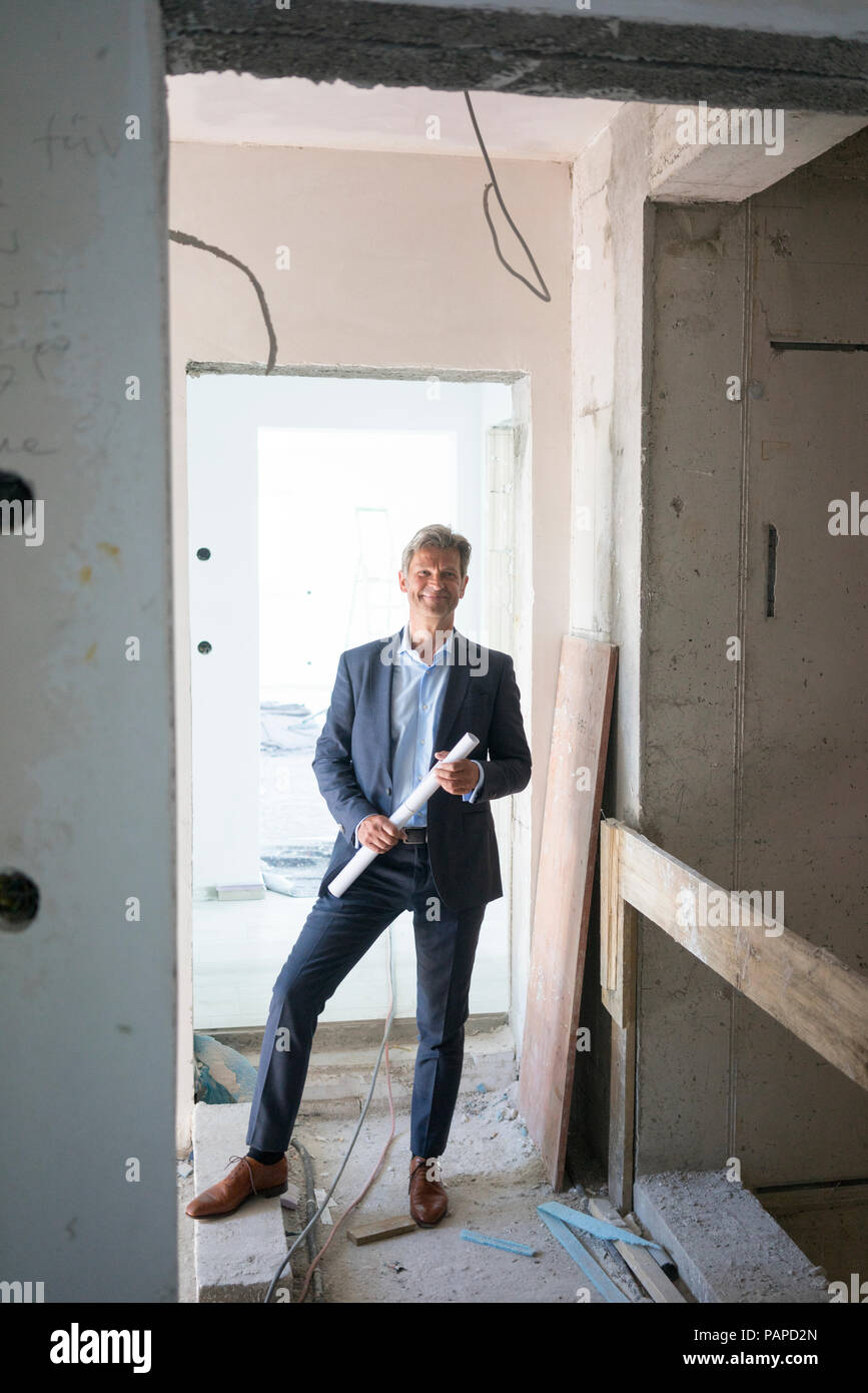 Portrait of smiling architect in building under construction Stock ...