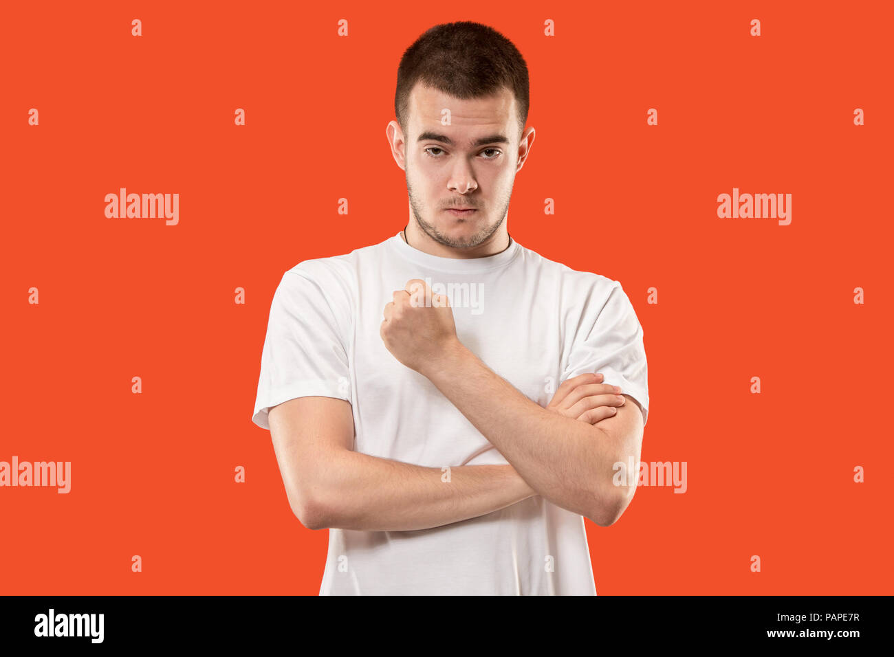 The young emotional angry man screaming on orange studio background ...