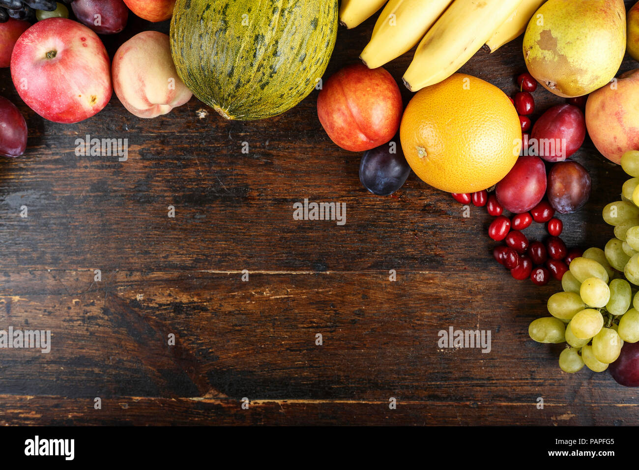 fruit background with exotic fruits on a brown wooden background, fruit ...