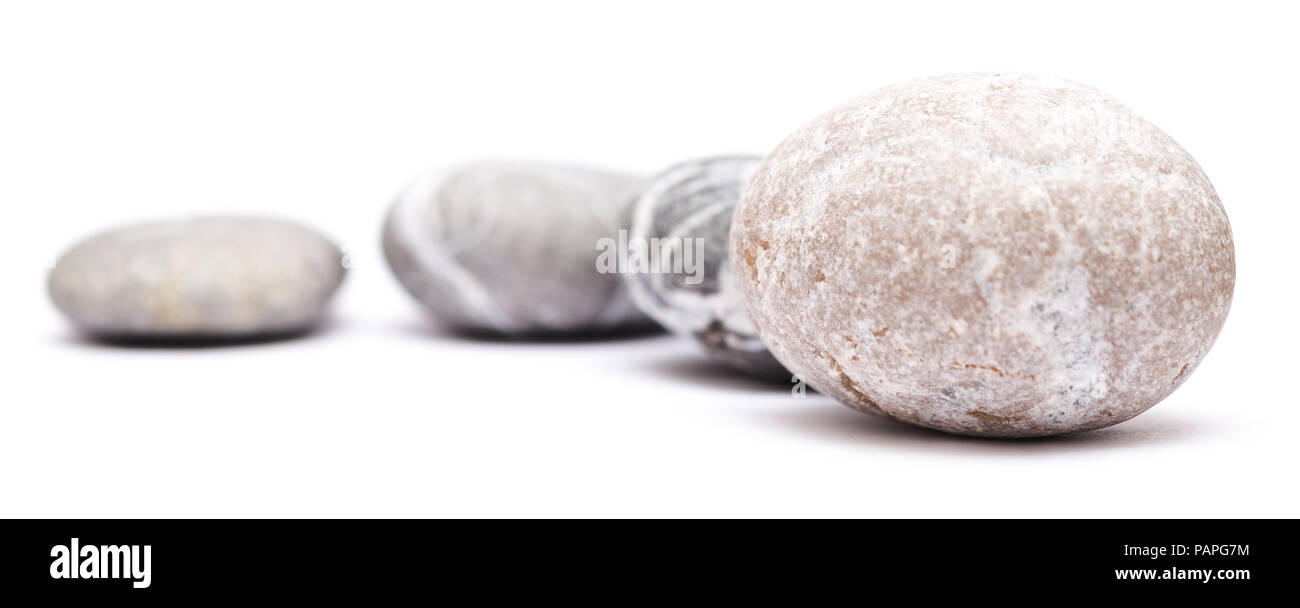 Row of stones isolated on white background Stock Photo - Alamy