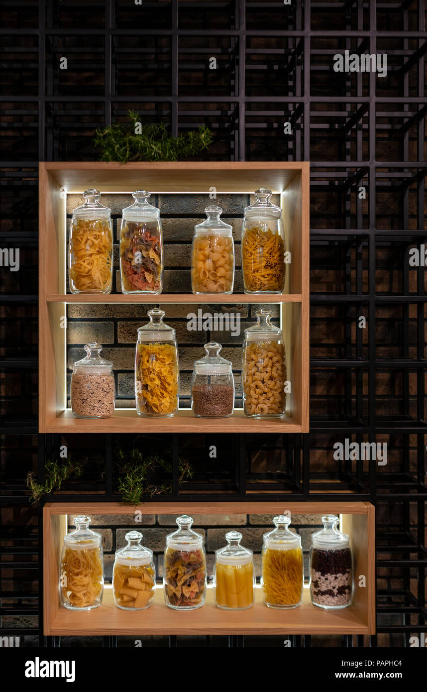 variable jars on a shelf in a modern interior with pasta, spaghetti ...
