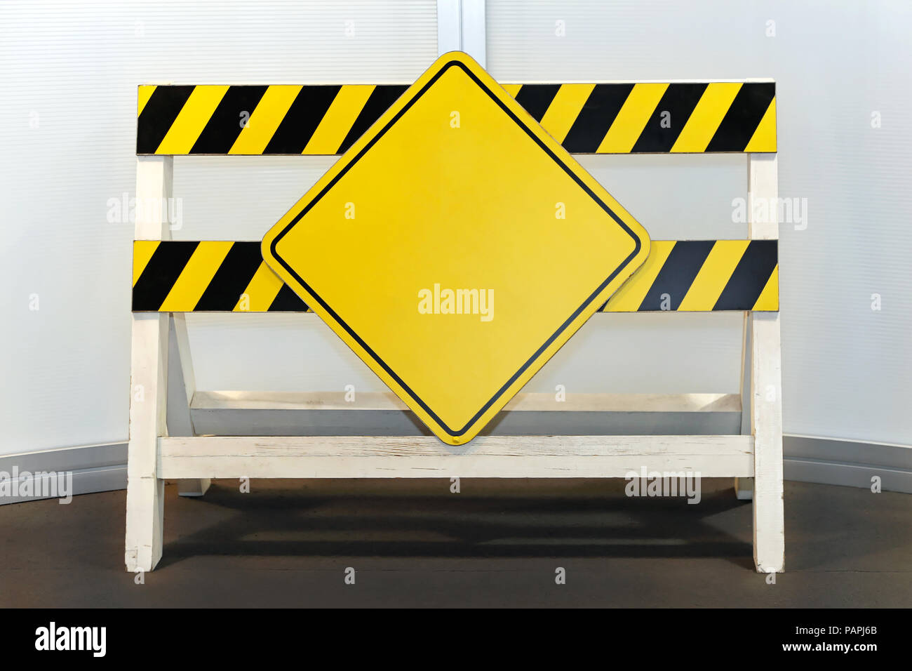 Blank yellow sign at construction barrier Stock Photo - Alamy
