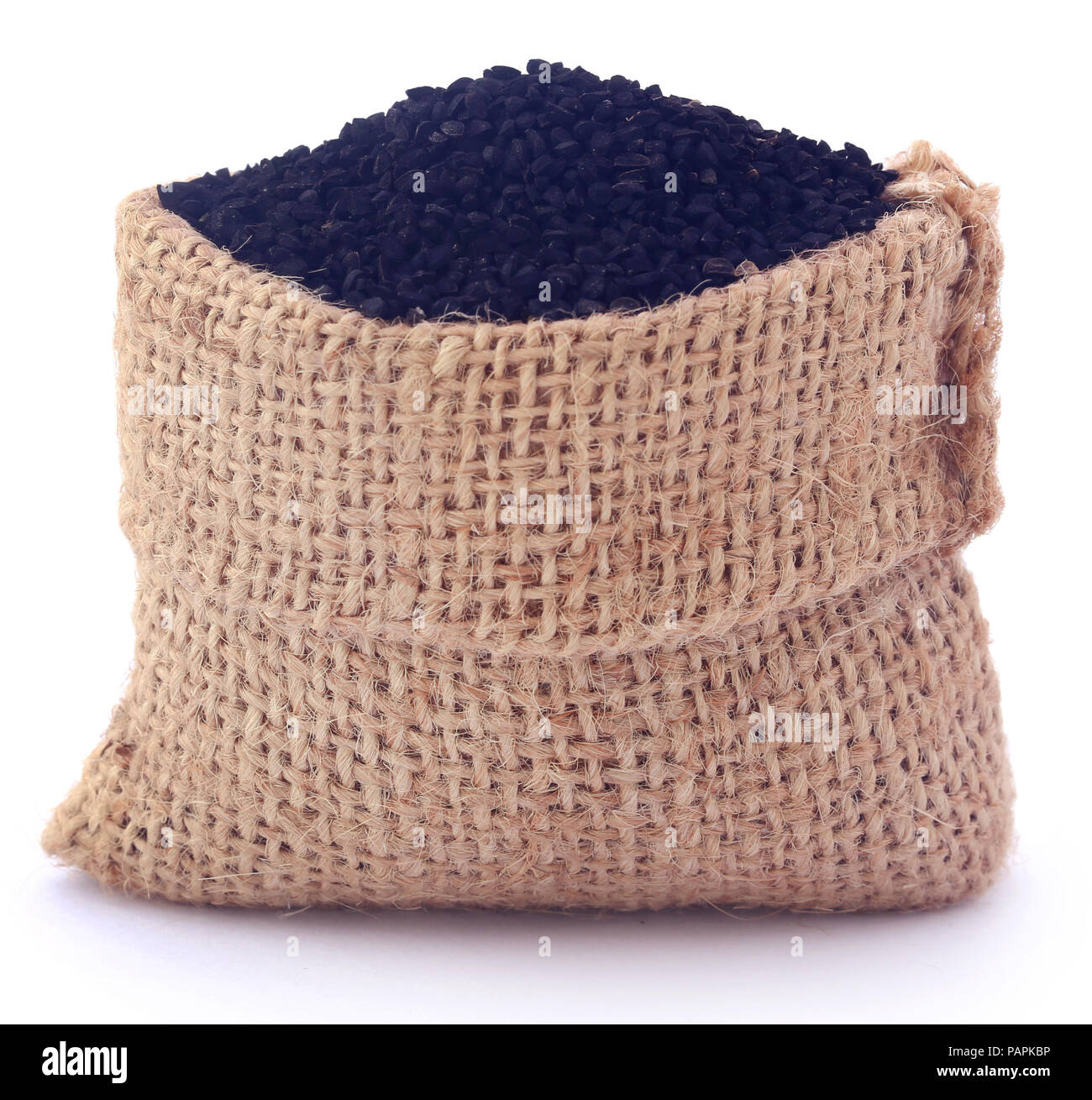 Nigella seeds in juje sack over white background Stock Photo - Alamy