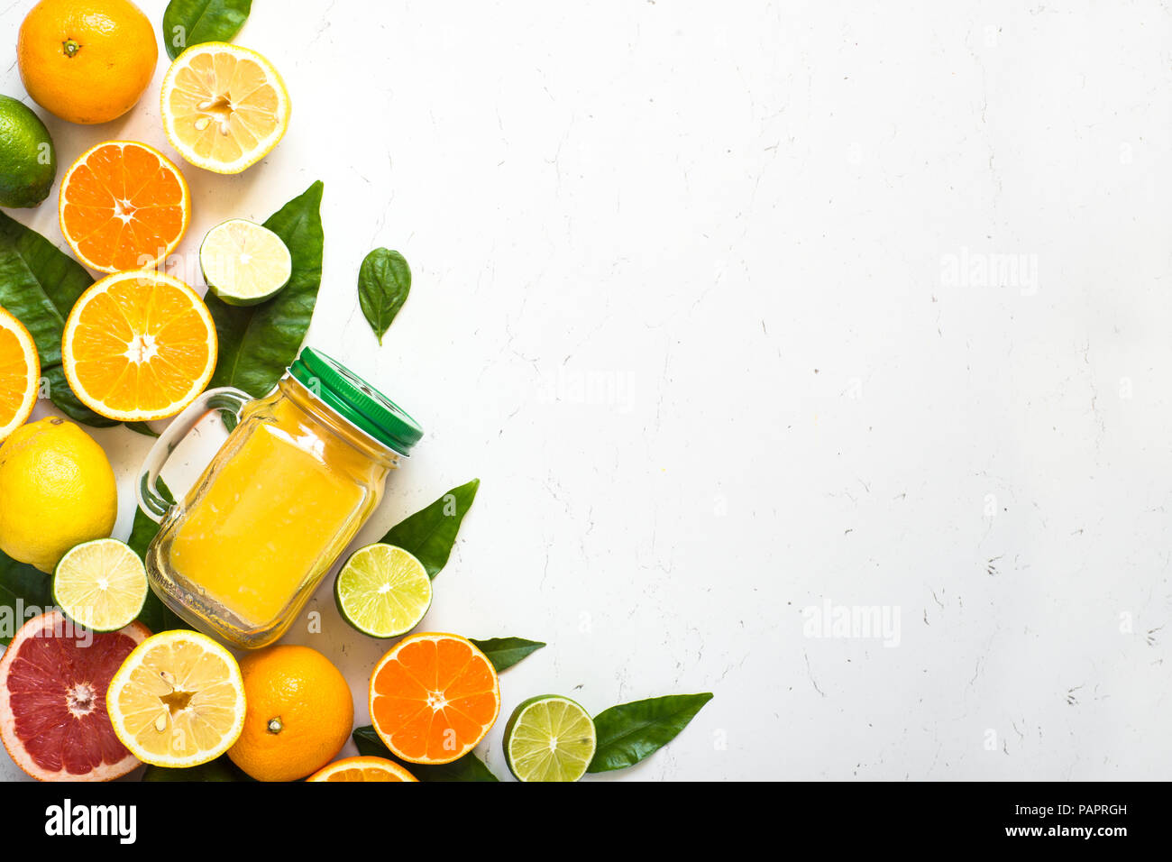 Citrus juice smoothie and ingredients on white. Fruit food background ...