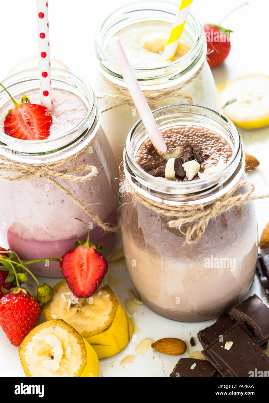 Set of milkshake in jars. Banana chocolate and strawberry milkshakes ...