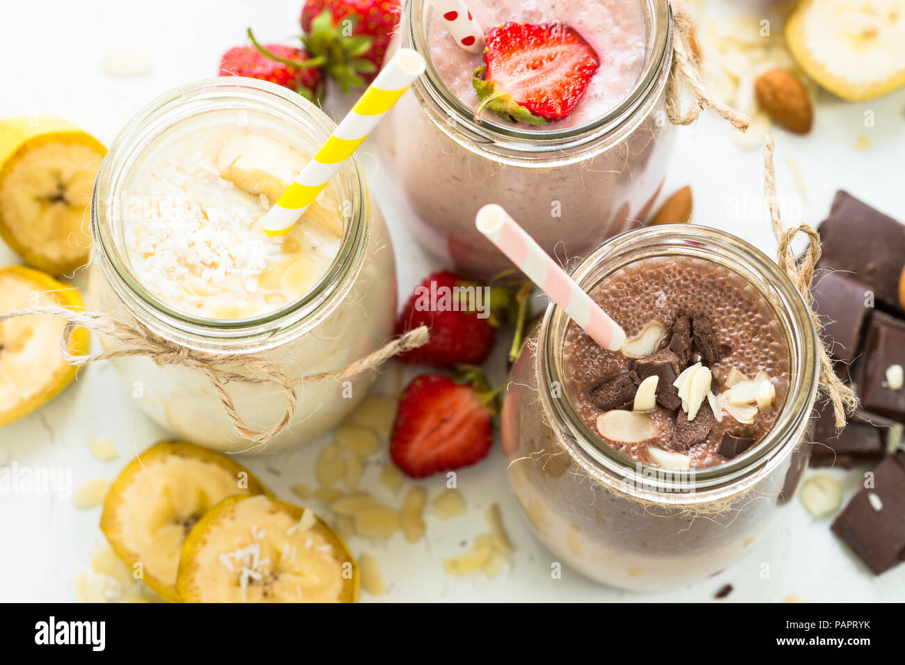 Set of milkshake in jars. Banana chocolate and strawberry milkshakes ...